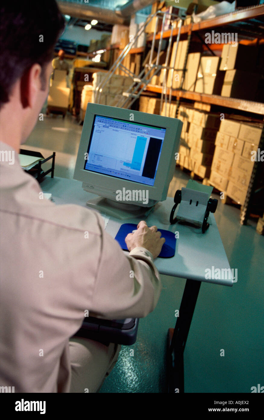 Man sitting on desk in warehouse hi-res stock photography and images ...