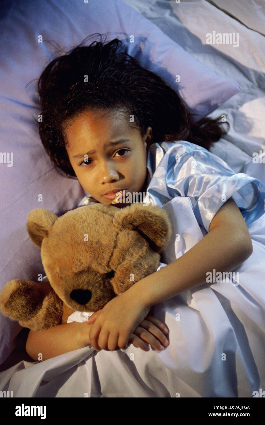 Sick girl lying in bed Stock Photo - Alamy
