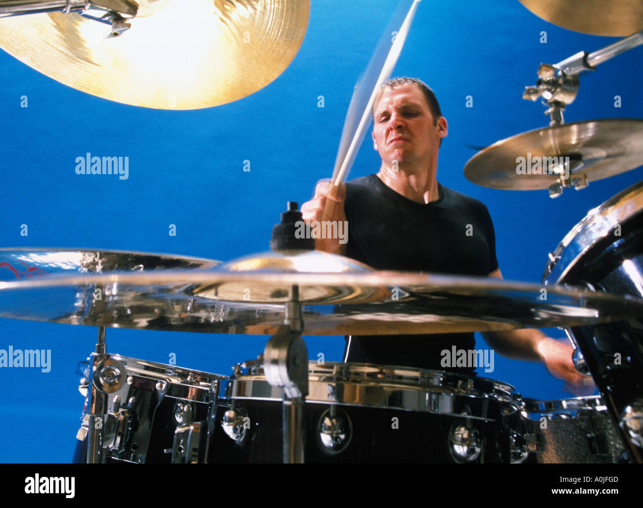 A young man playing the drums Stock Photo - Alamy