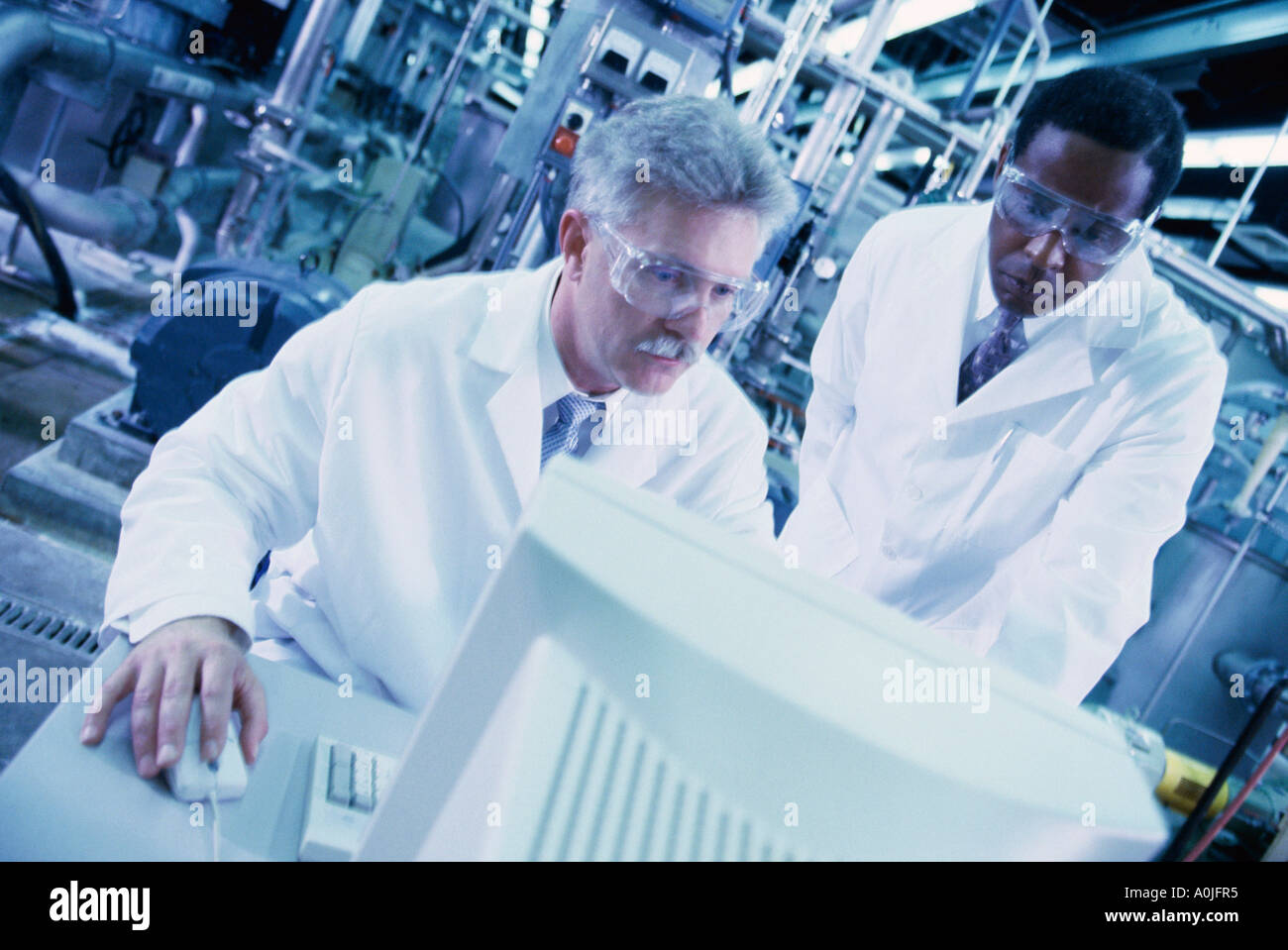 Two male researchers working on a computer Stock Photo - Alamy