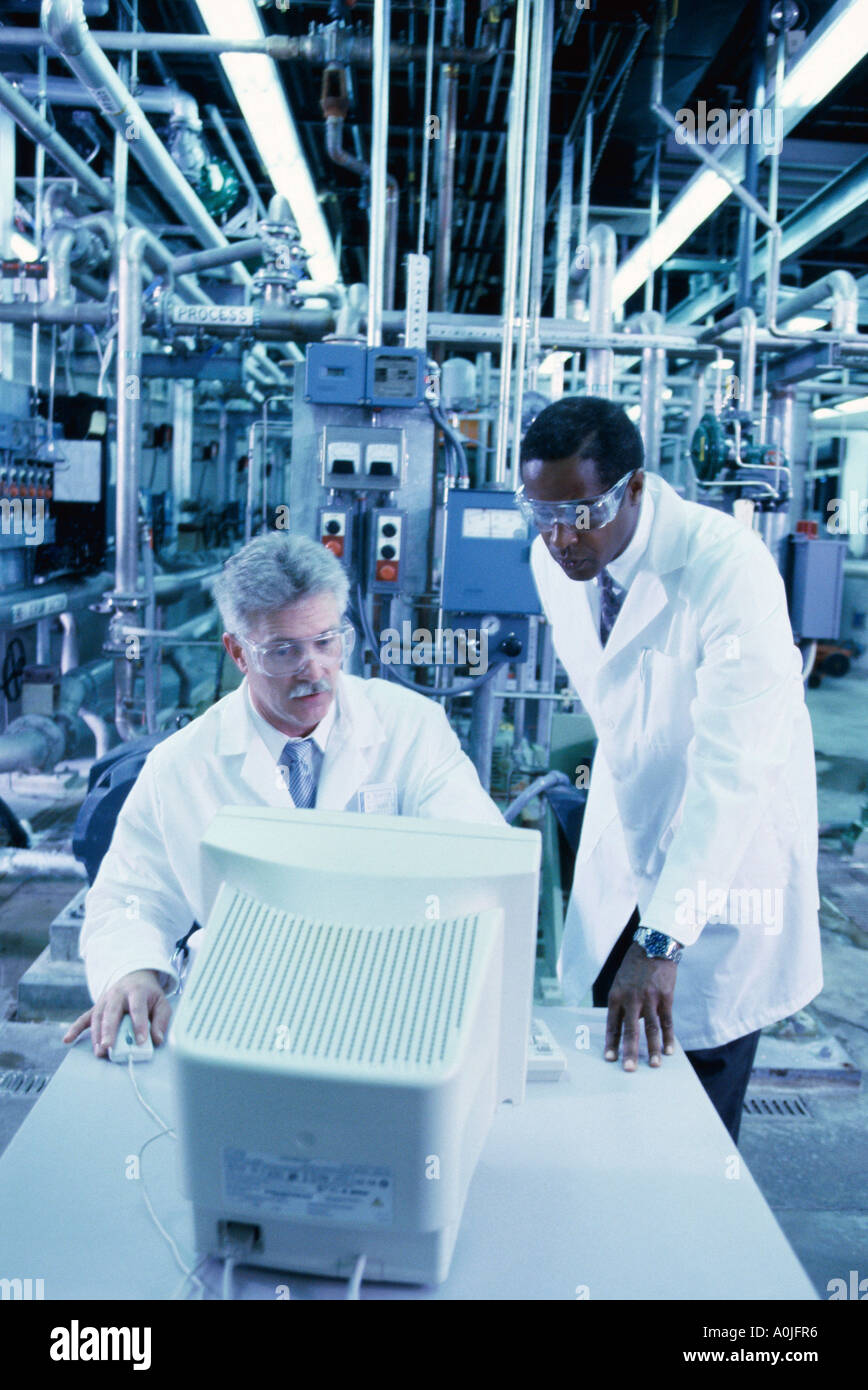 Two male researchers working on a computer Stock Photo - Alamy