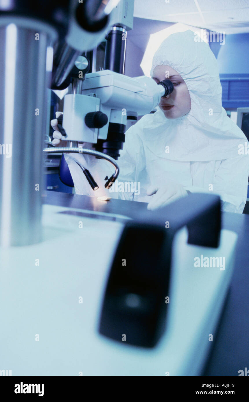 Female researcher looking through the microscope Stock Photo - Alamy