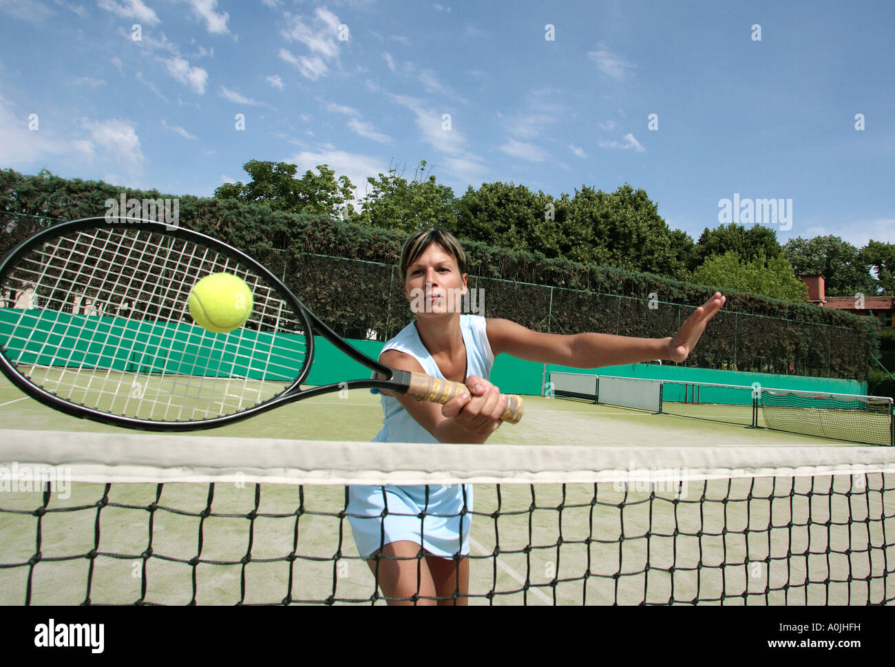Front View of Female Tennis Player Hitting Ball Stock Photo - Alamy