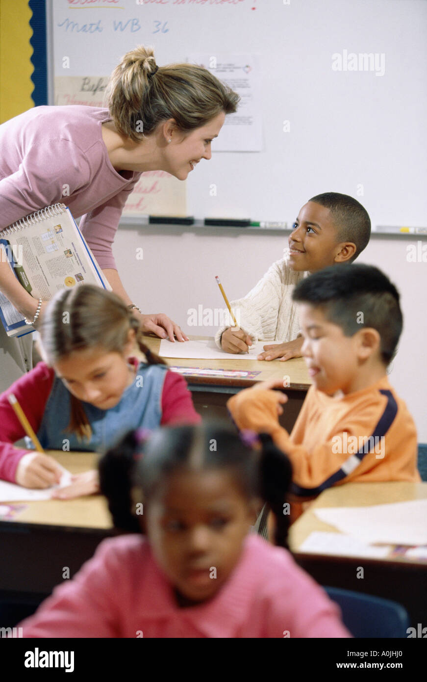 School children in a classroom with a female teacher Stock Photo - Alamy