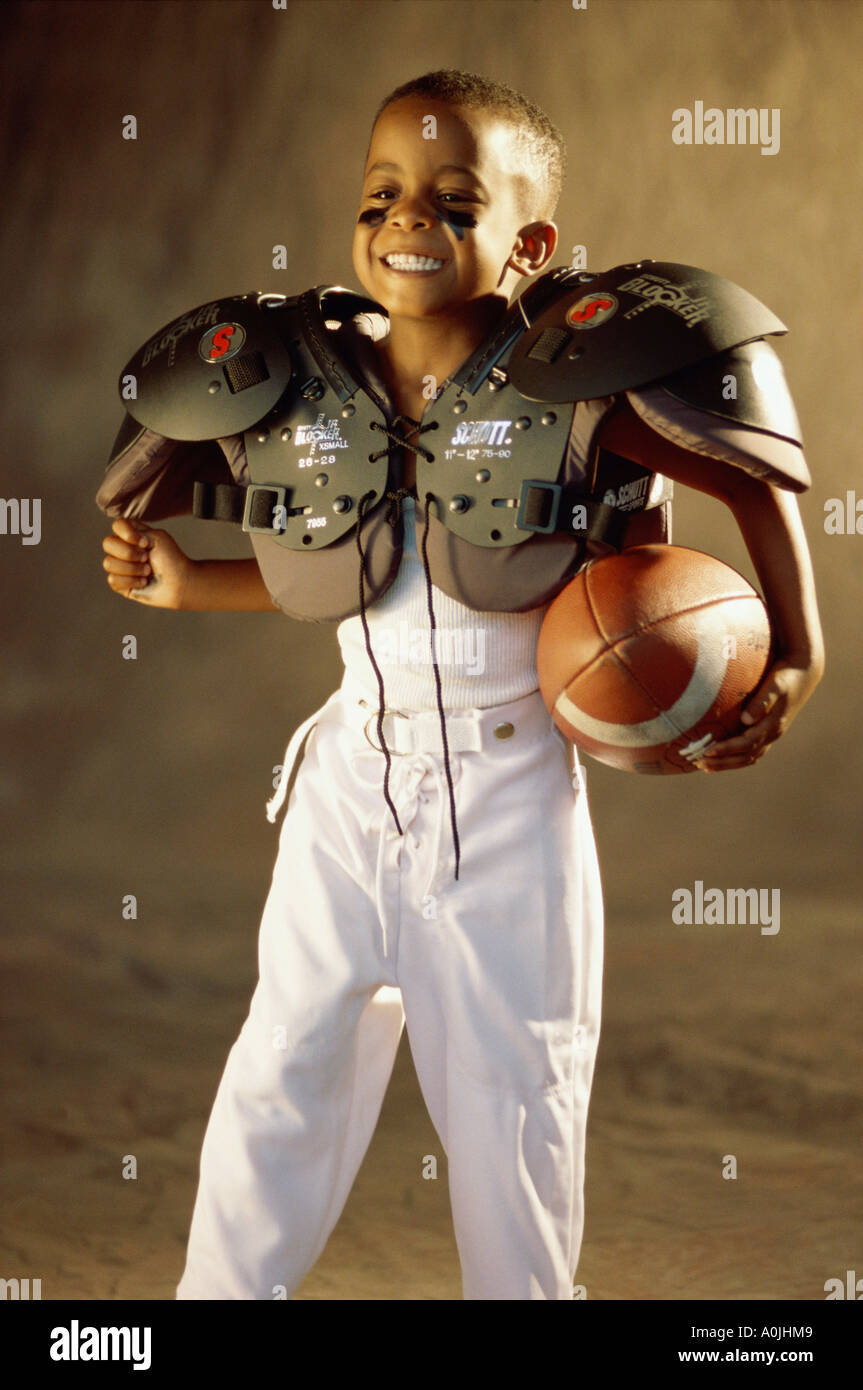 Boy in a football uniform holding a ball Stock Photo - Alamy