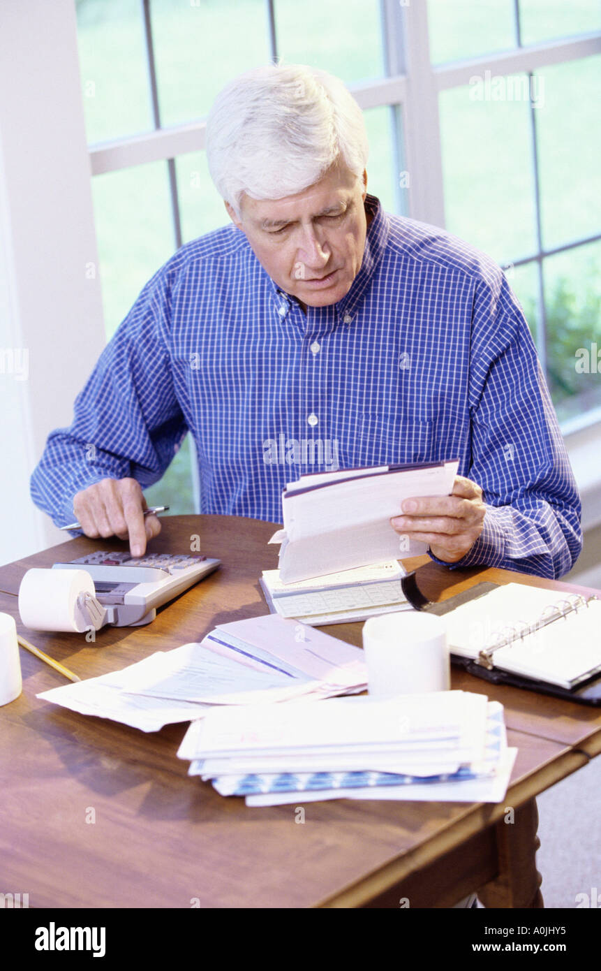 Senior man calculating bills Stock Photo - Alamy