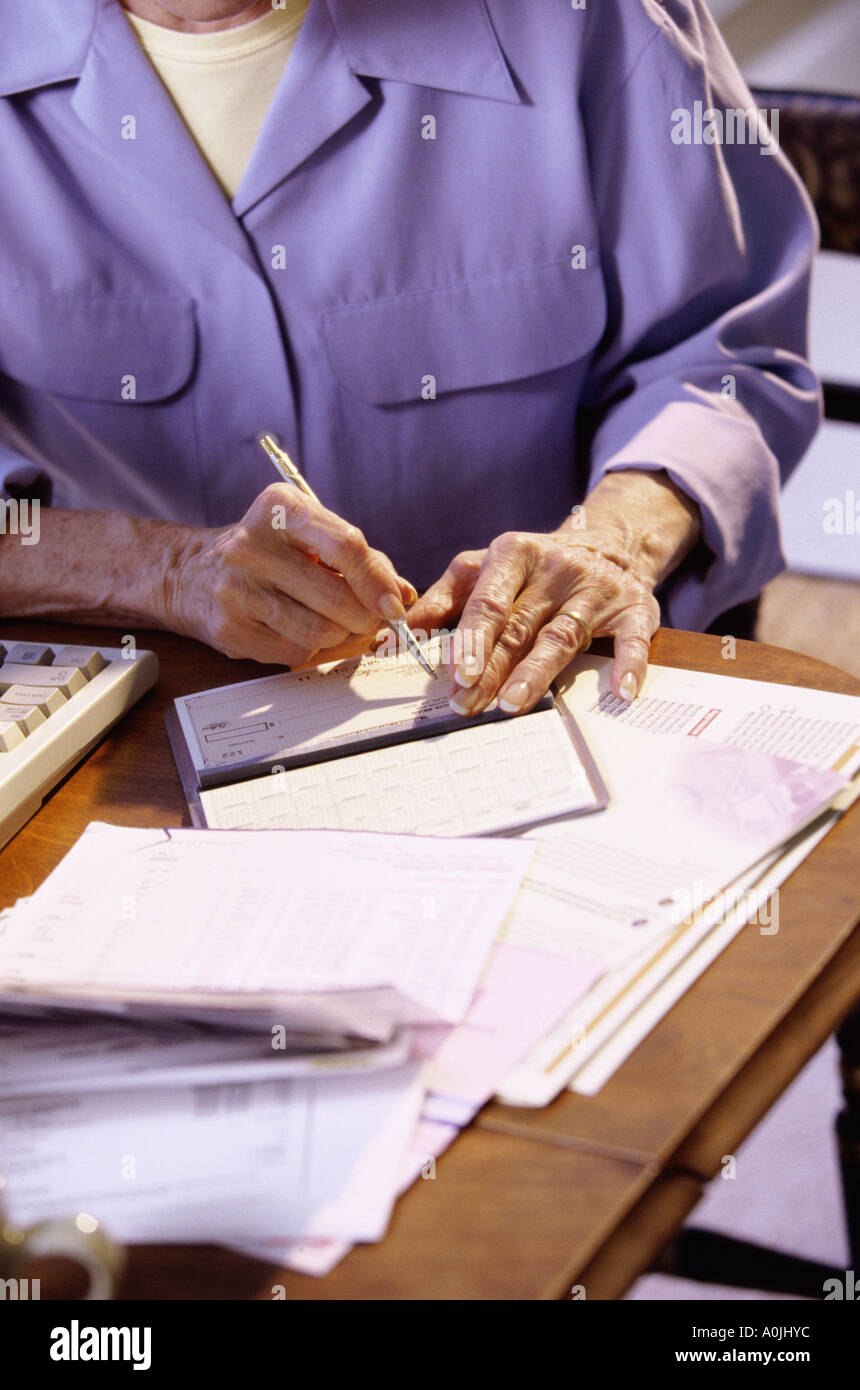 Person writing a check Stock Photo - Alamy