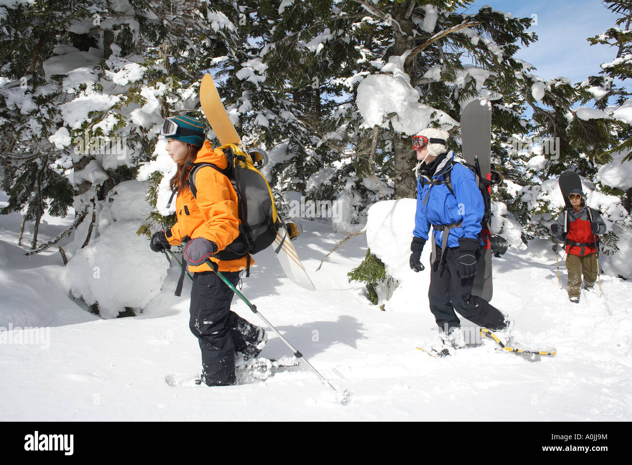 Snowboarders trudging through snow Stock Photo - Alamy