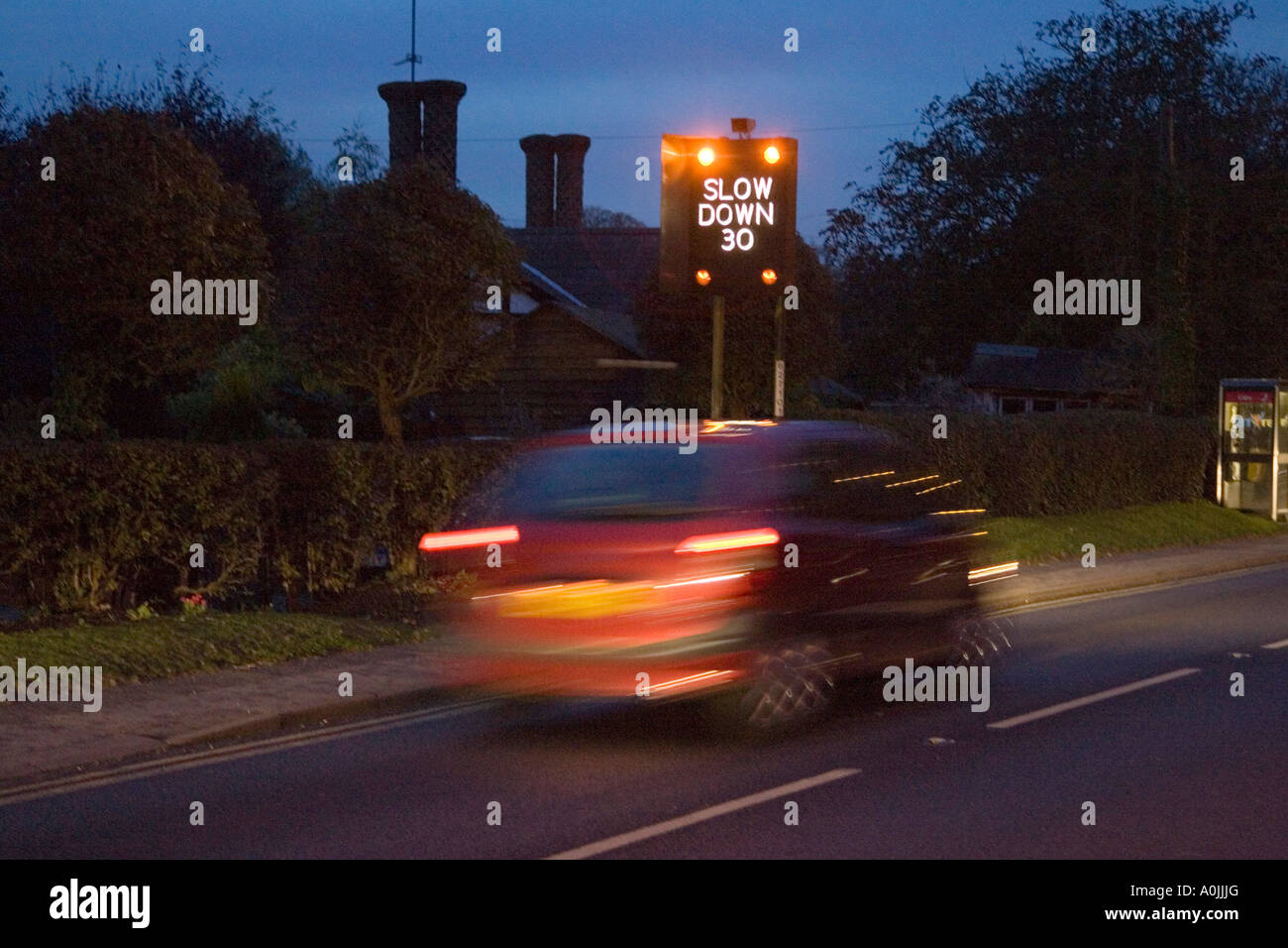 a flashing speed warning sign and fast moving traffic Stock Photo - Alamy