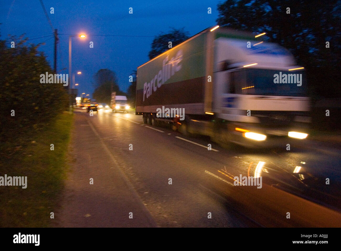 fast moving rush hour traffic through a village Stock Photo - Alamy
