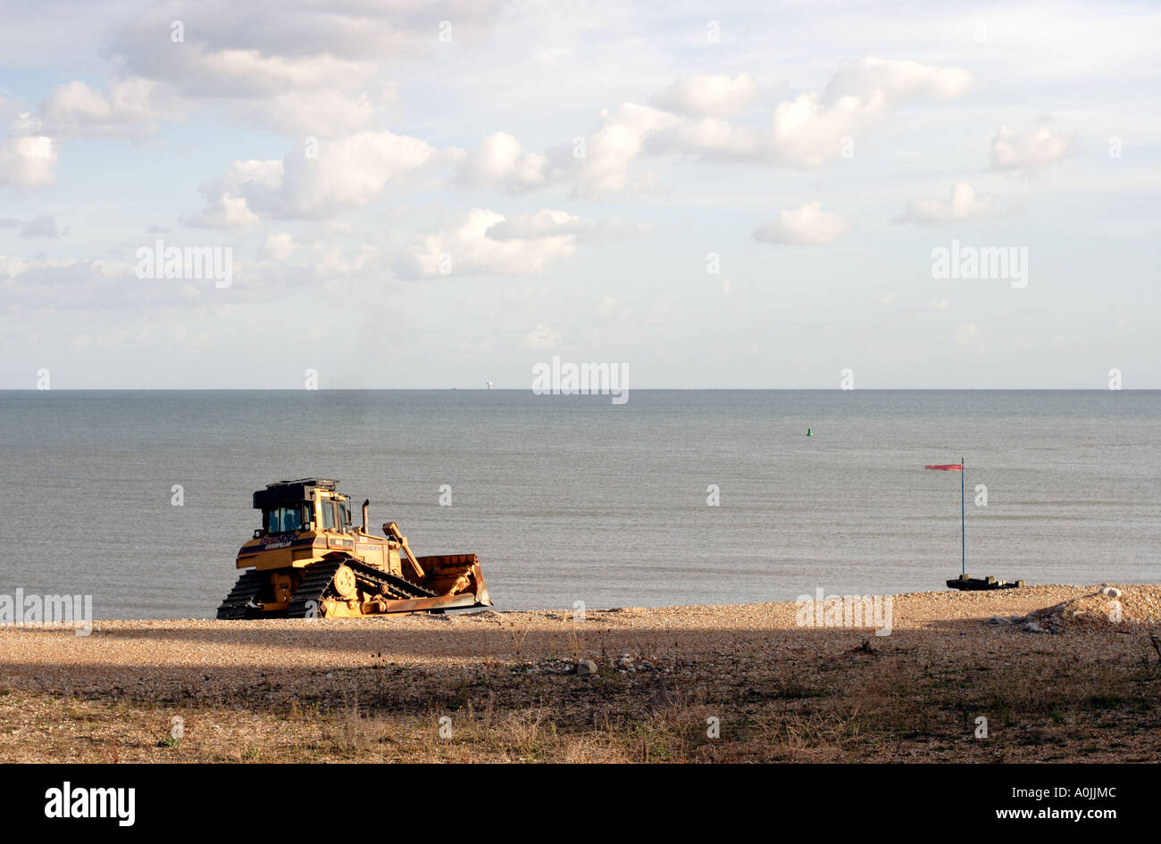 Bulldozer working on beach Stock Photo - Alamy