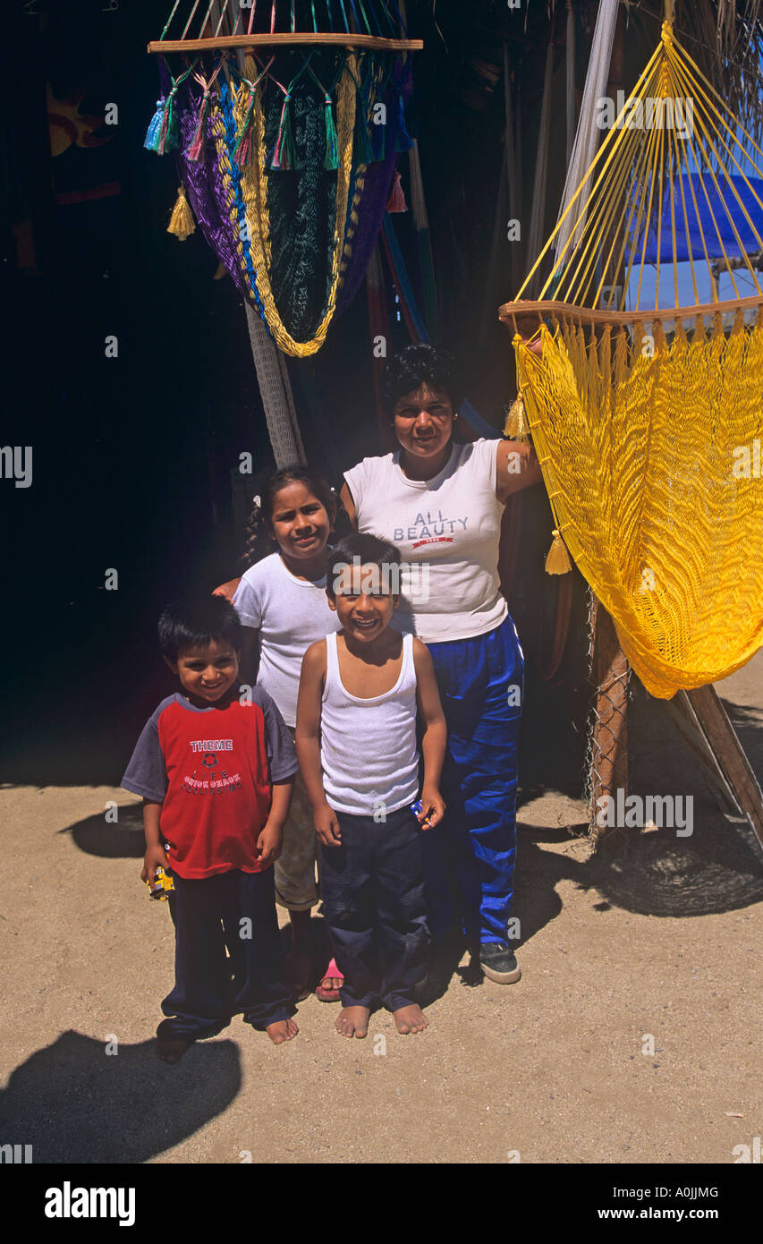 The owner and his family pose outside their shop beside a colourful ...