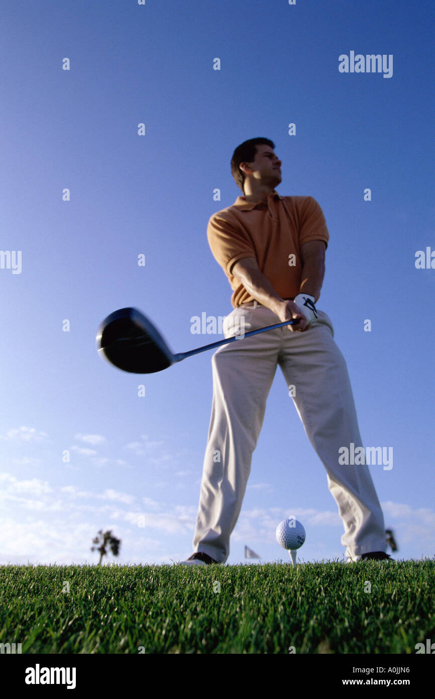 Low angle view of a young man playing golf Stock Photo - Alamy