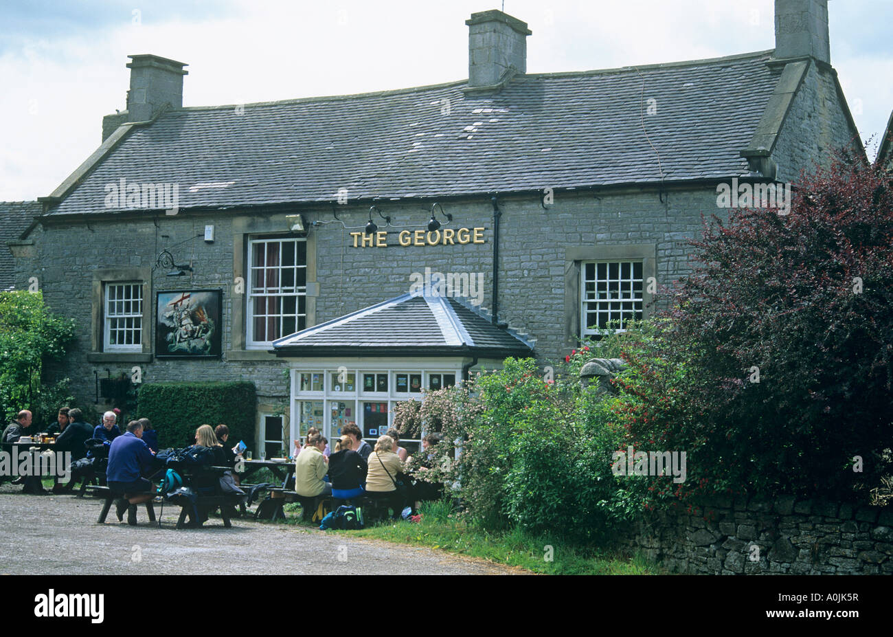 People eating and drinking sitting outside the George Inn Peak District ...