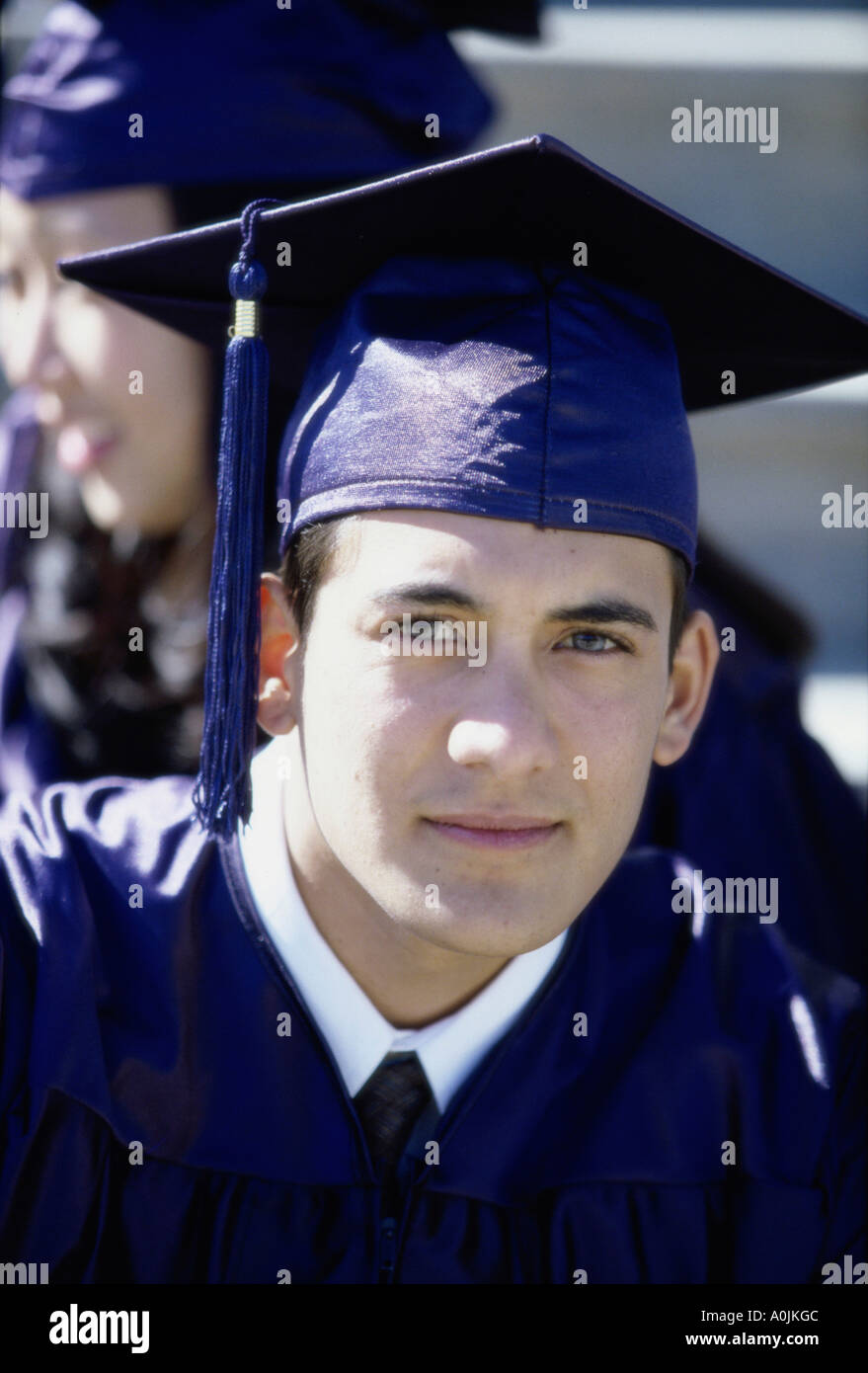 Portrait of a young male graduate smiling Stock Photo - Alamy