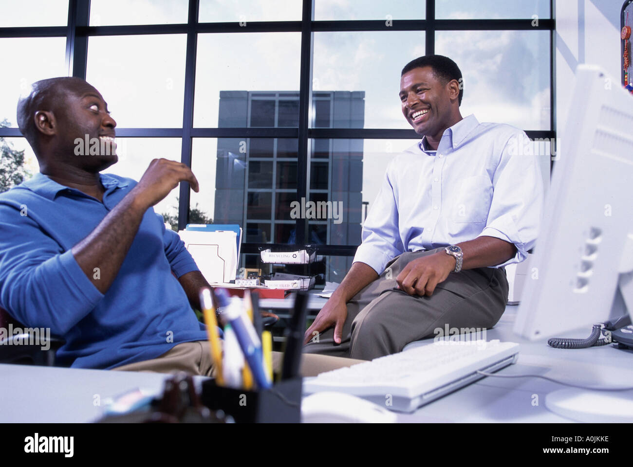 Two businessmen talking in an office Stock Photo - Alamy