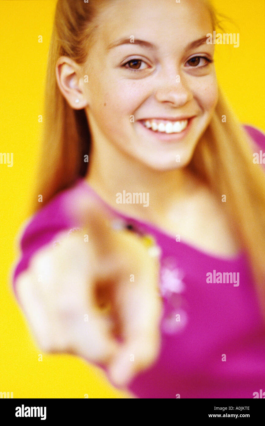 Portrait of a teenage girl pointing forward Stock Photo - Alamy