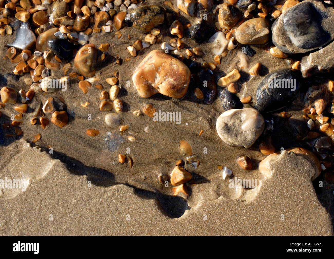 Pebbles and sand Stock Photo - Alamy