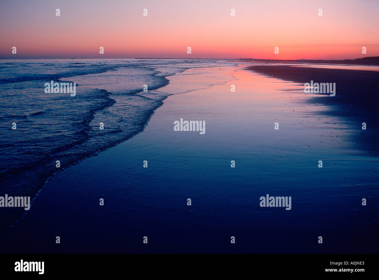 Atlantic Ocean. Sandy shore at sunset Stock Photo - Alamy