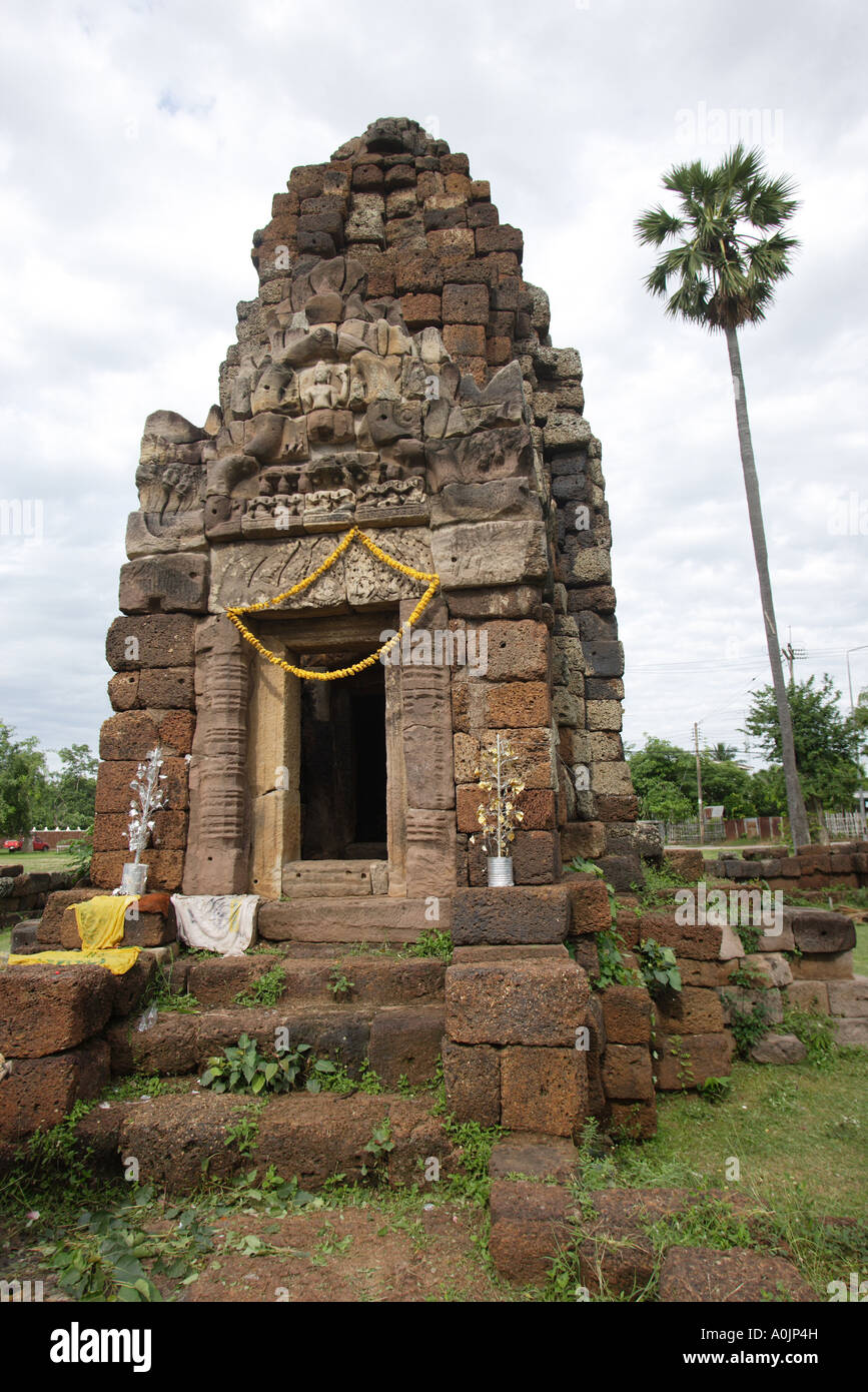 Prang Ku Khmer Tower A tall thin tree behind with branches growing in a ...