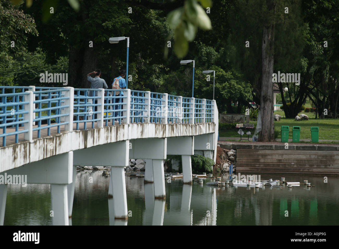 People walking on bridge over the lake at Town Park in Loei Stock Photo ...