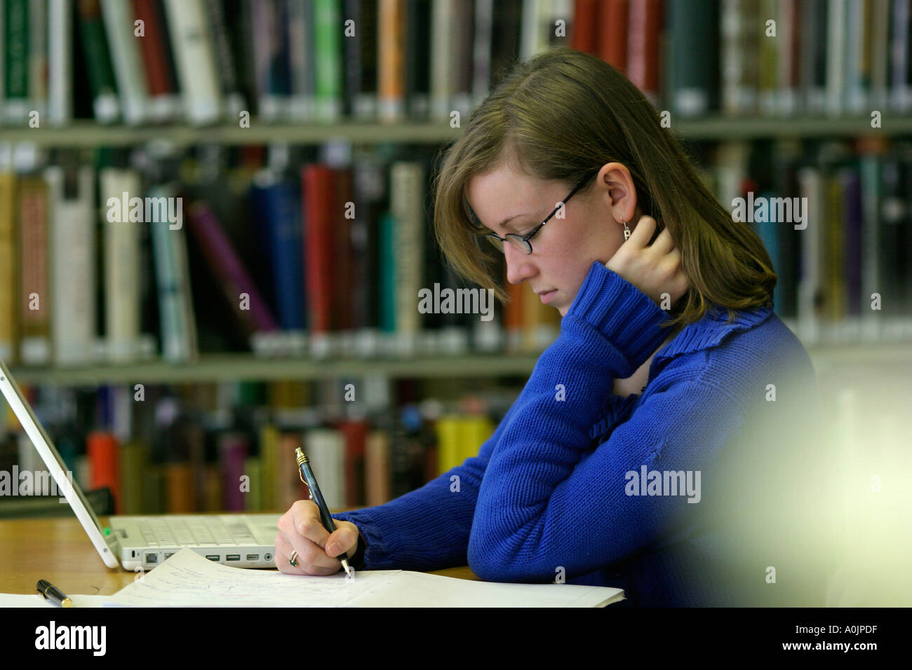 Student young woman working in a library Student young woman working in ...