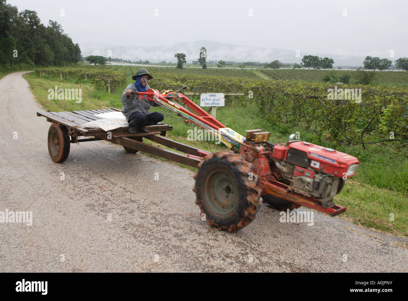 Man driving a very strange trailer along a road at Chateau De Loei ...
