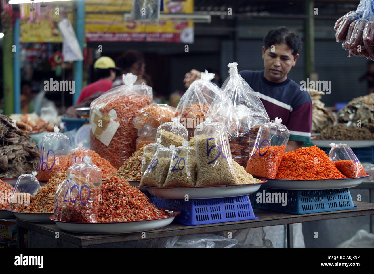 A man selling types of dried fish in a market in Chumphon Southern ...