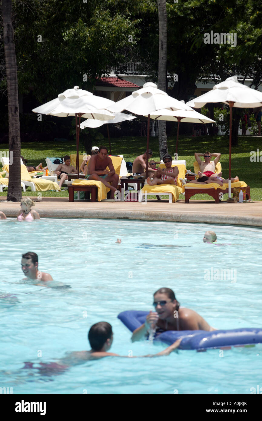 People lounging and swimming at the pool at the Sofitel Hua Hin Resort ...
