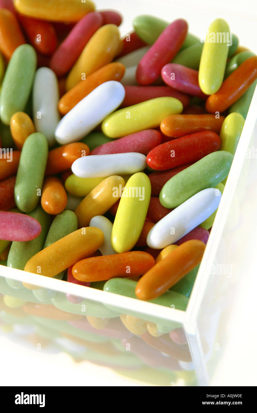 Plastic box of multicoloured liquorice torpedoes, also known as ...