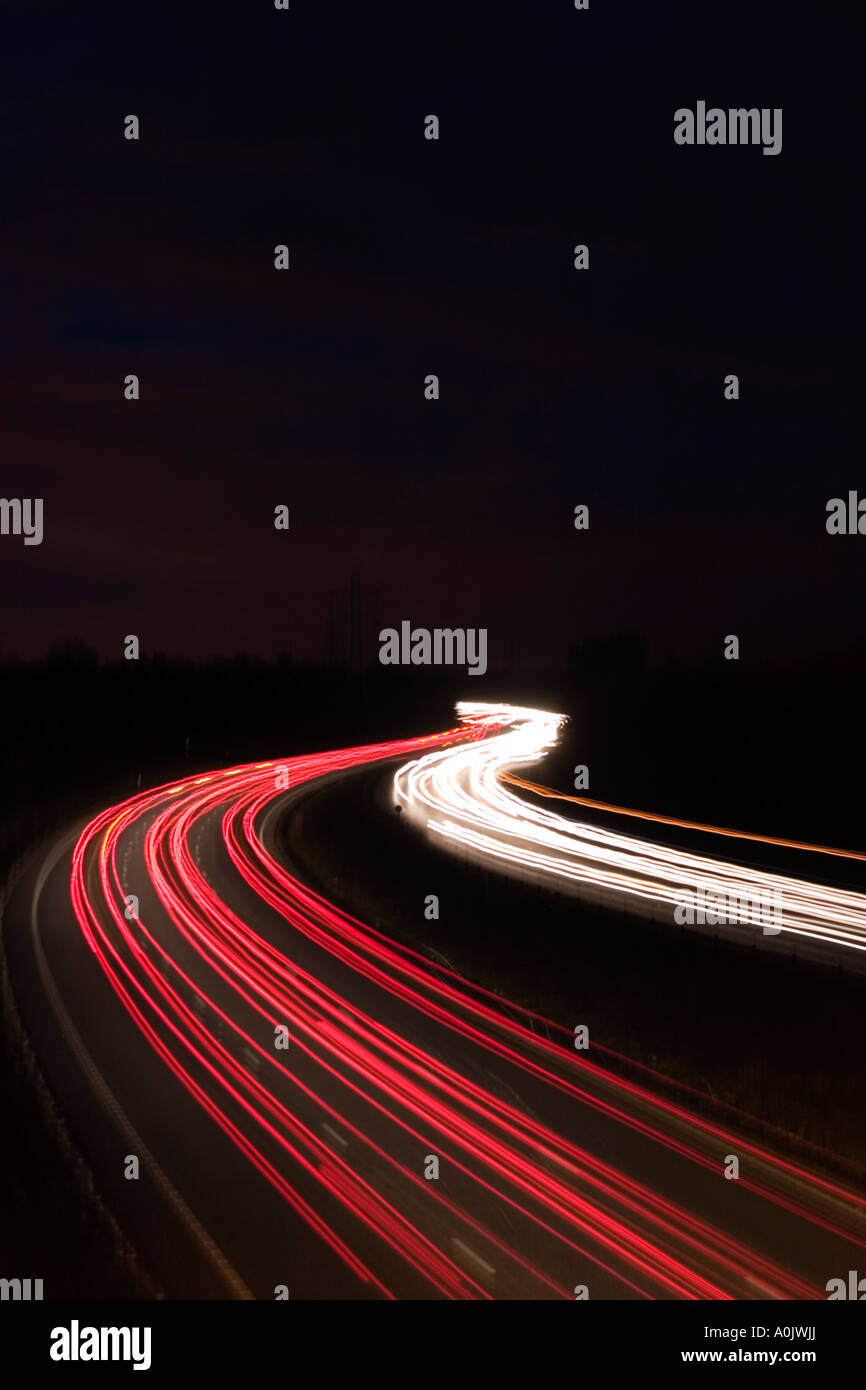 Cars create a snaking light trail on a road at night Stock Photo - Alamy