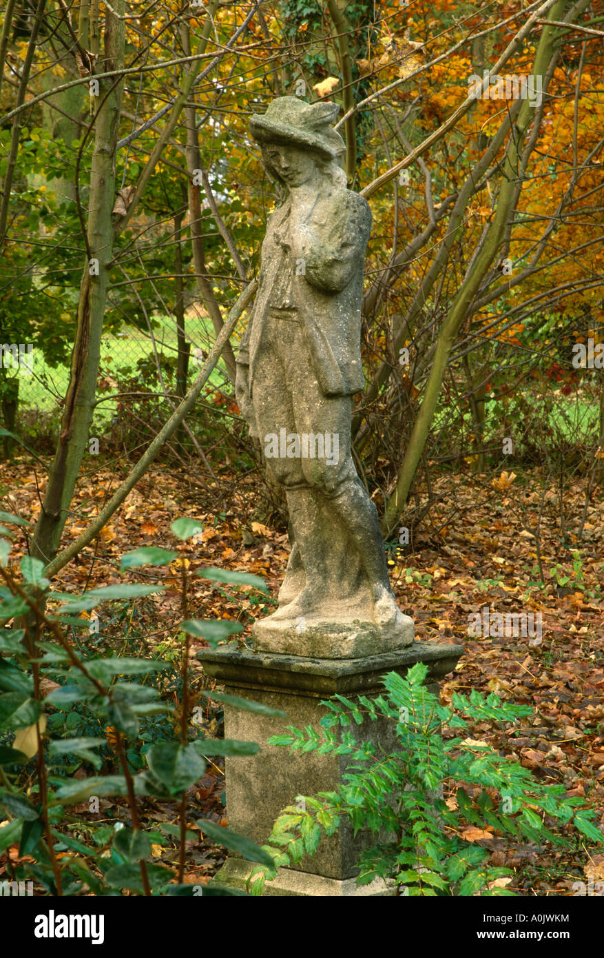Statue in woodland with Autumn leaves on ground Stock Photo - Alamy
