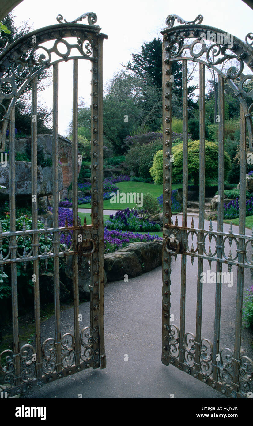 View through wrought iron gates to large country garden Stock Photo - Alamy
