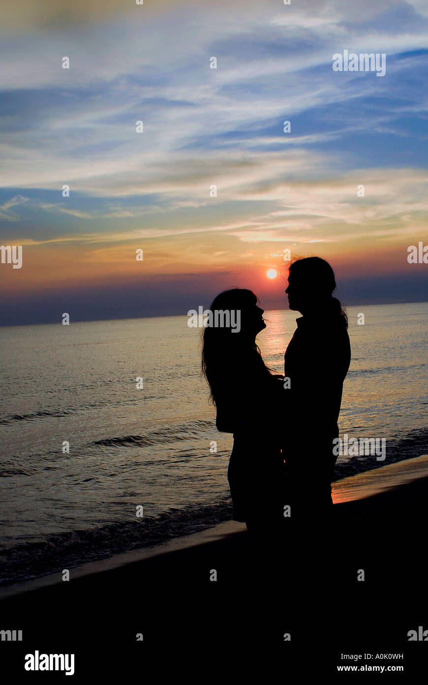 Romantic couple at sunset Stock Photo - Alamy