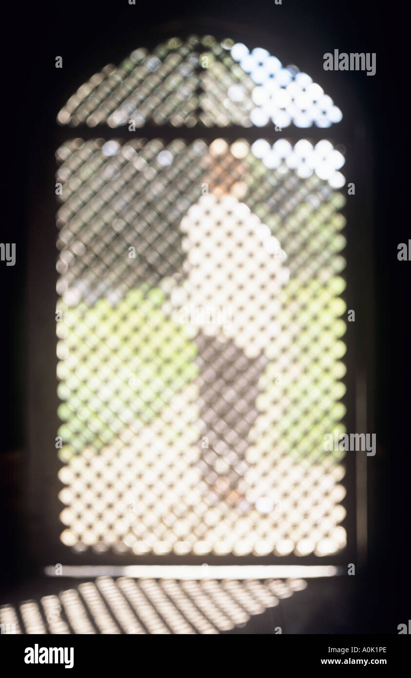 Impressionistic view from indoors of a figure standing outside in ...