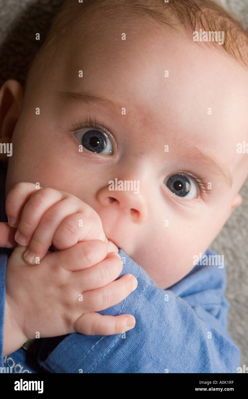 colour image off a close up shot off a young baby boys face.looking ...
