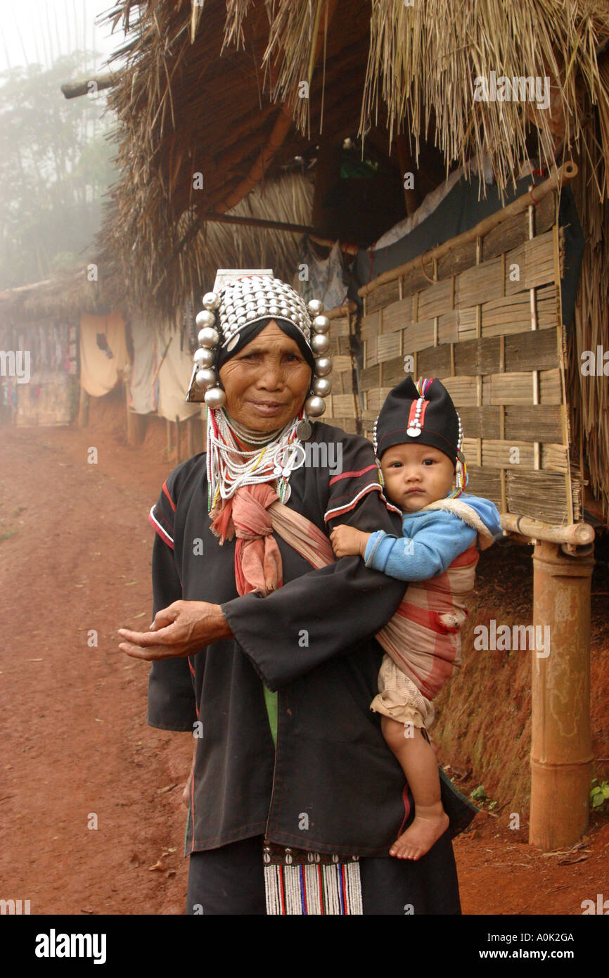 Akha woman carrying child on her back, Northern Thailand Stock Photo ...