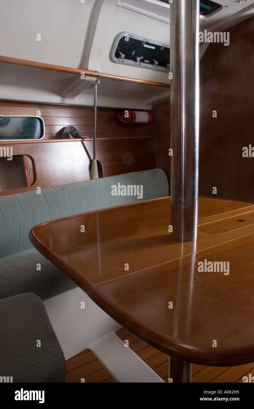 colour image off the inside off a boat interior which is all brown wood ...