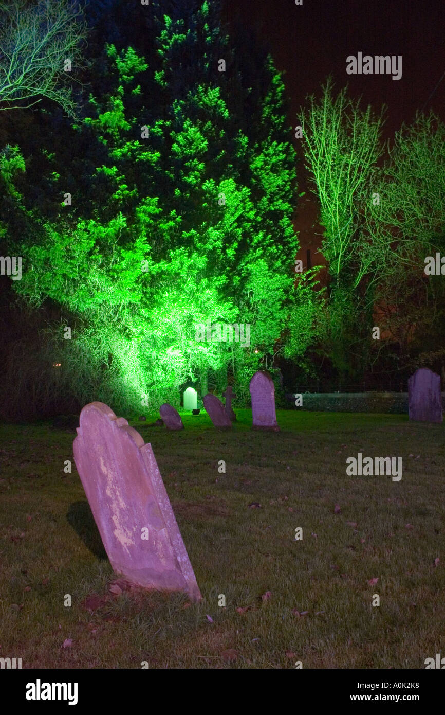 colour image off a church grave yard at night time which is all lit up ...