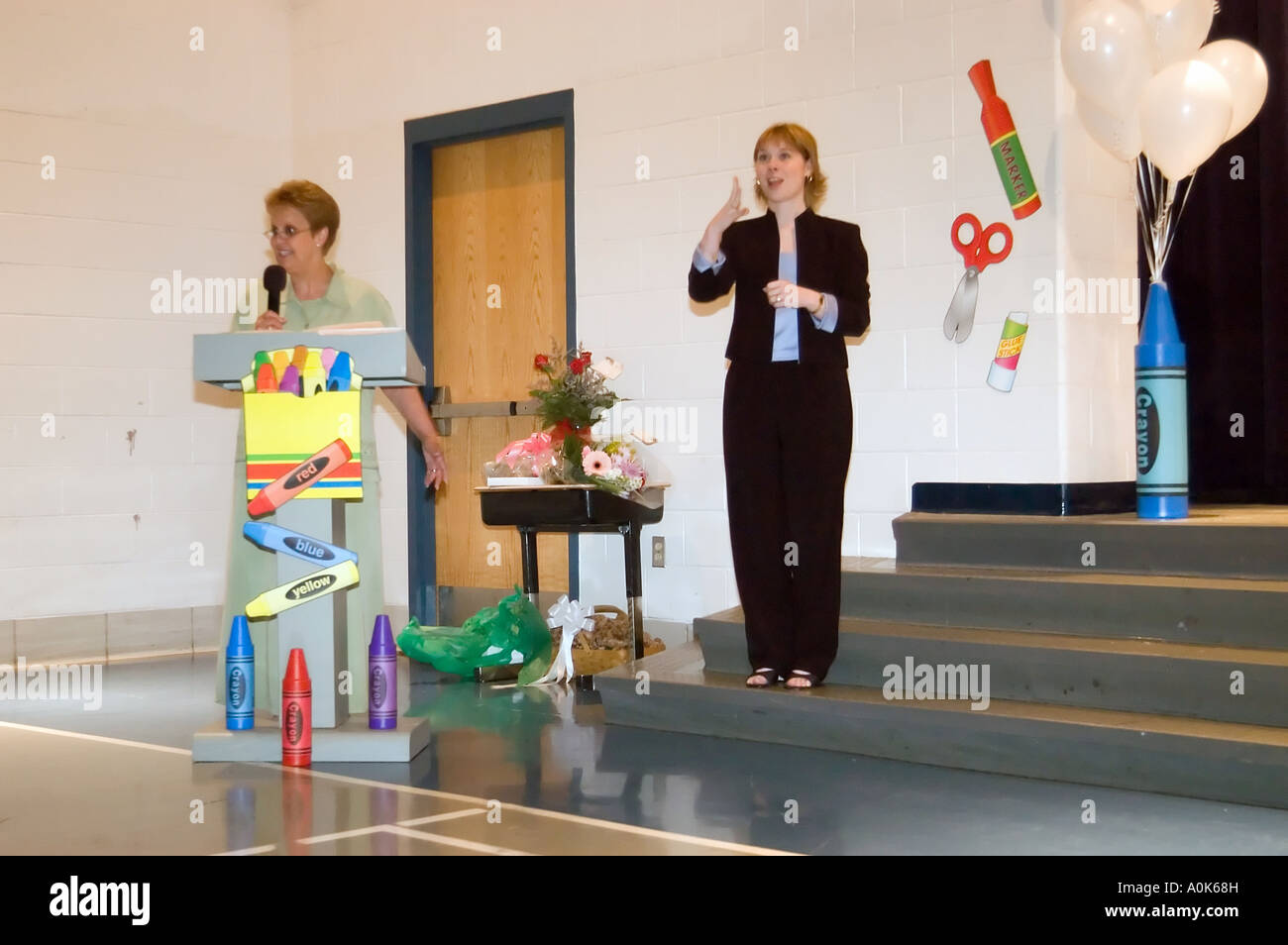 P31 306 Preschool graduation speaker at podium with person signing sign ...