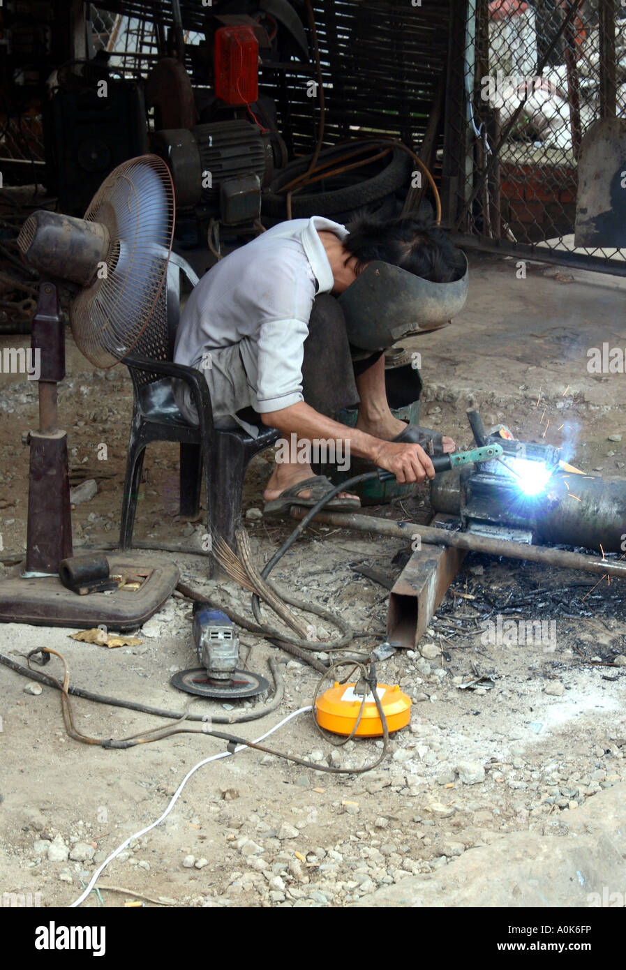 A man repairing a gear wheel in the Mekong Delta, Vietnam Stock Photo ...