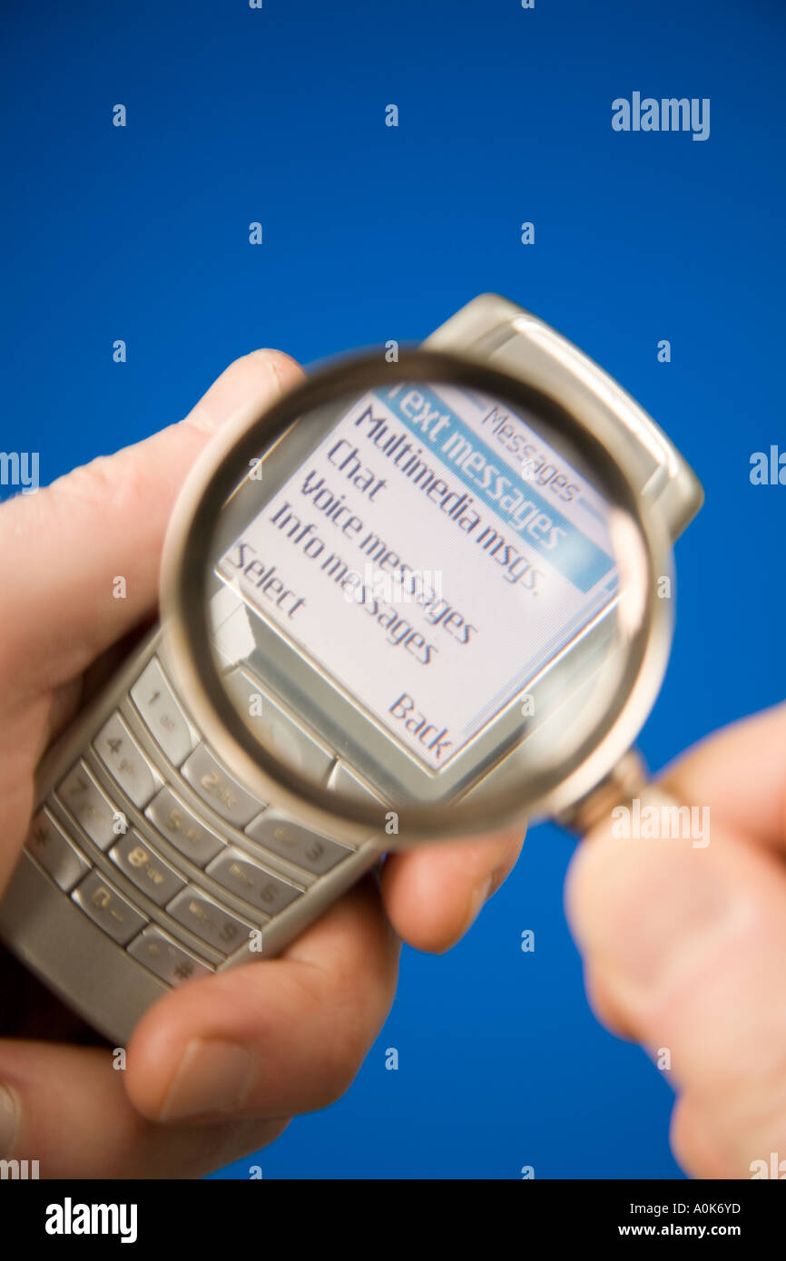 Mobil phone under a magnifying hi-res stock photography and images - Alamy