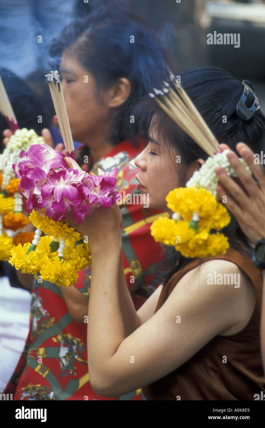 Buddhist women worship at the Erawan shrine in Bangkok Thailand Stock ...