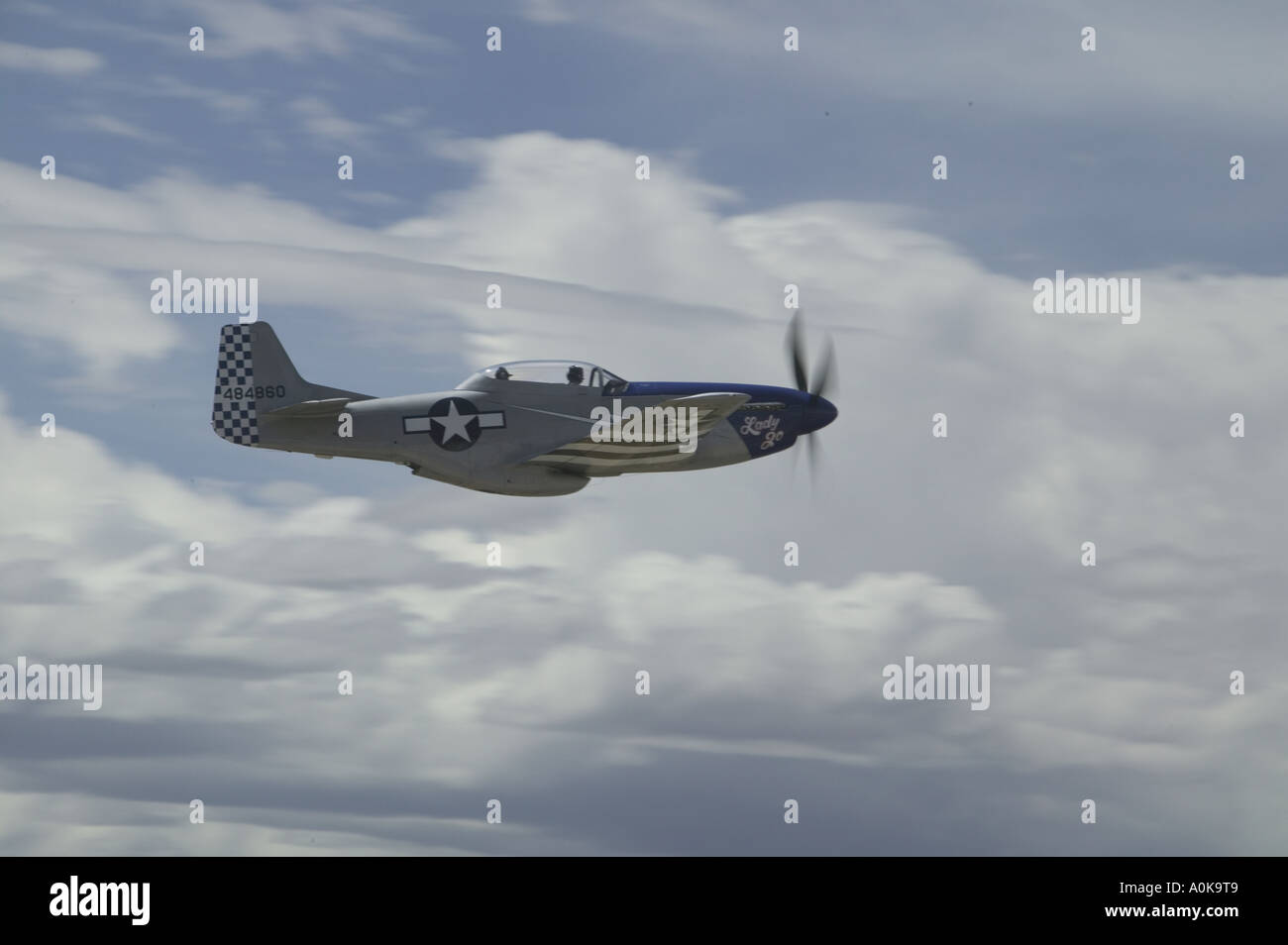 North American P51 Mustang in flight profile against cumulus clouds ...