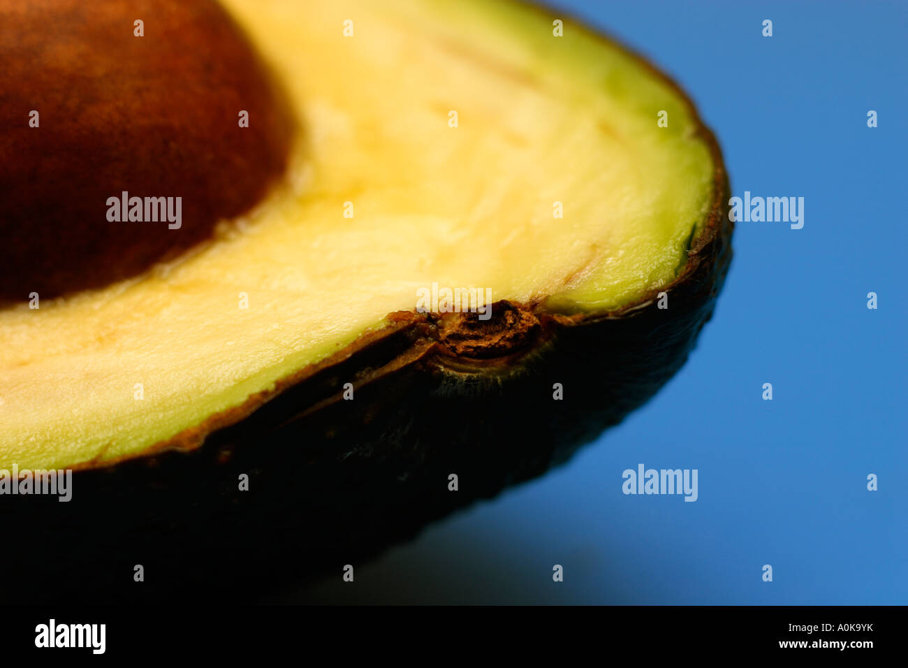 avocado fruit cut in half showing the seed and flesh Stock Photo - Alamy