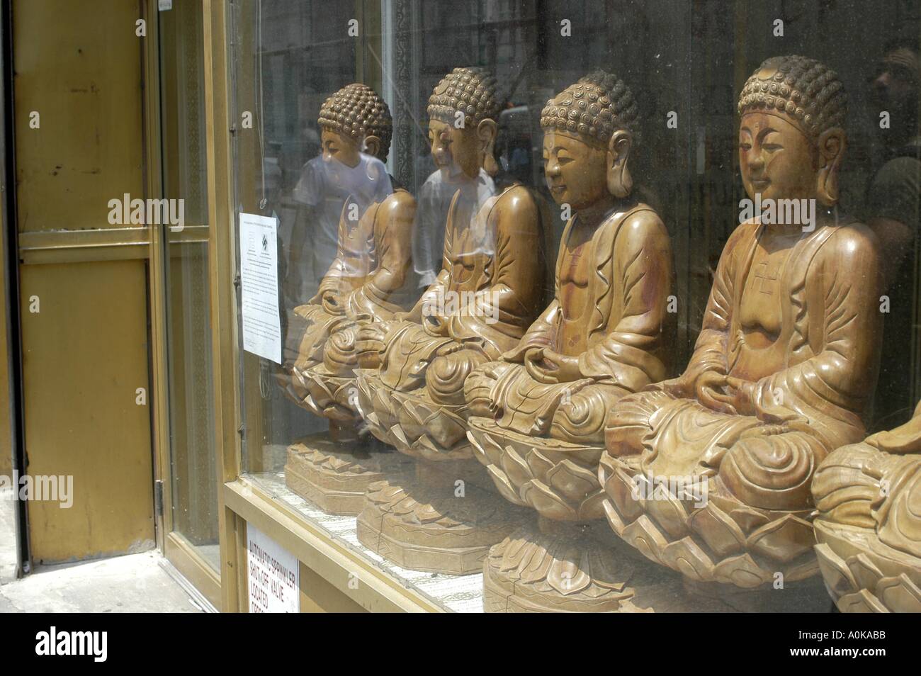 Buddha statues or sculptures in the display window of a buddhist center ...
