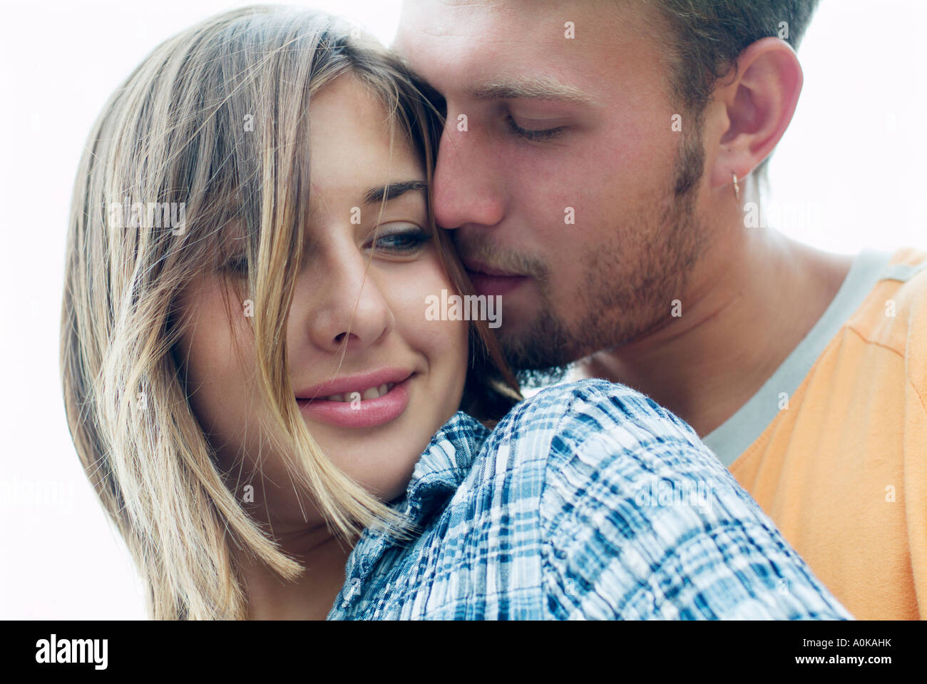 young woman being embraced by boyfriend Stock Photo - Alamy