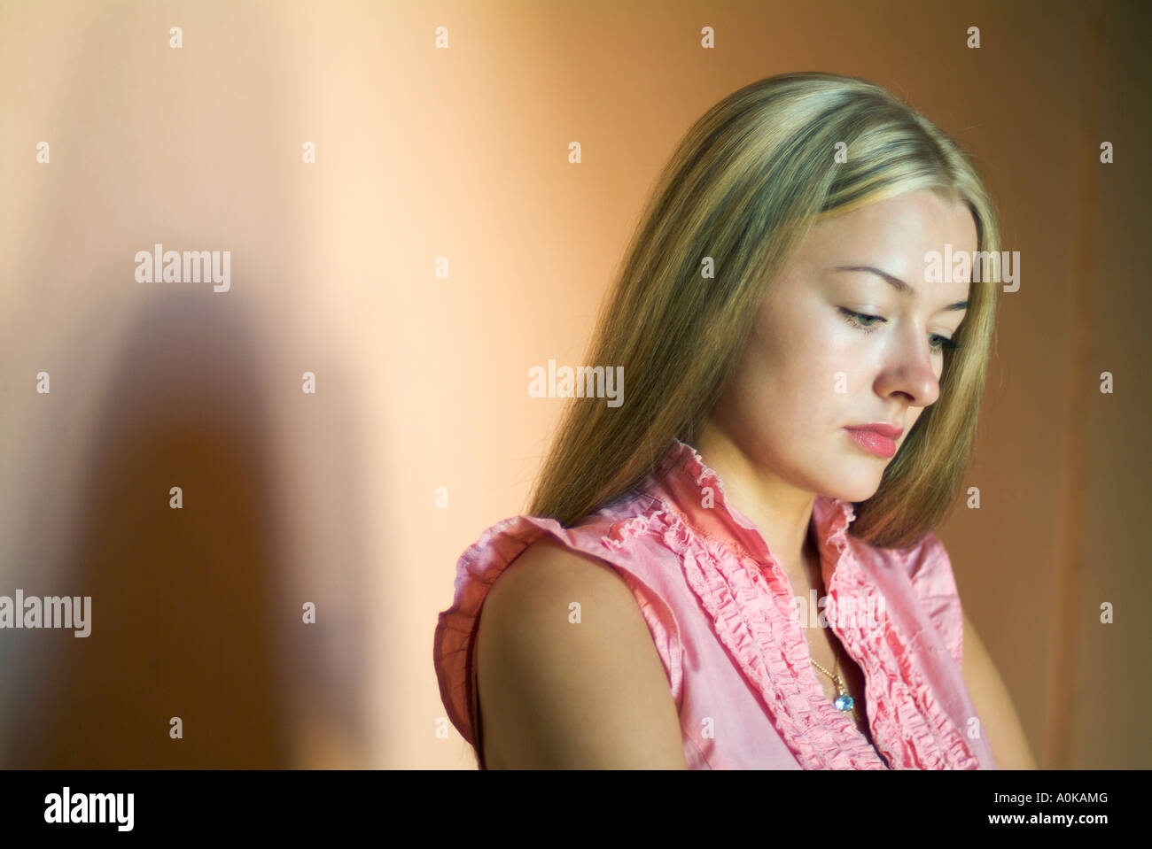 sad looking woman with dark shadow behind her Stock Photo - Alamy
