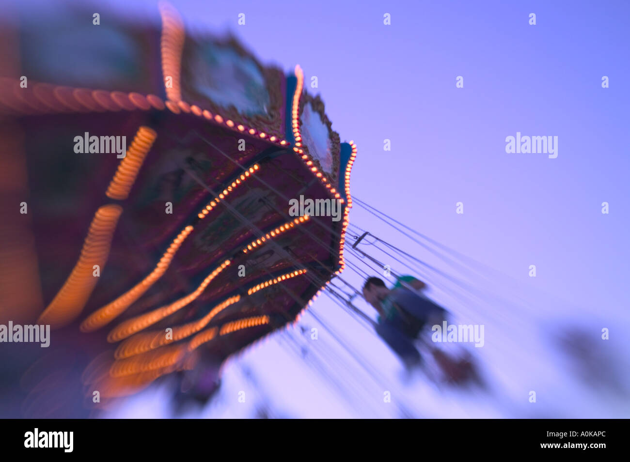 Swing ride lit up in evening on the midway, Western Idaho Fair, Boise ...