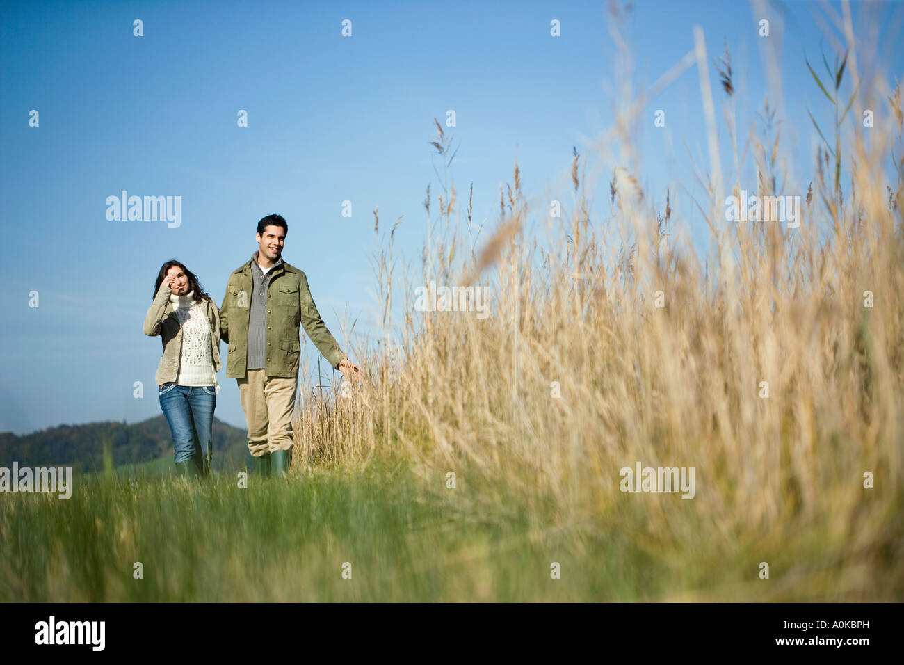 young couple having a walk in autumn Stock Photo - Alamy
